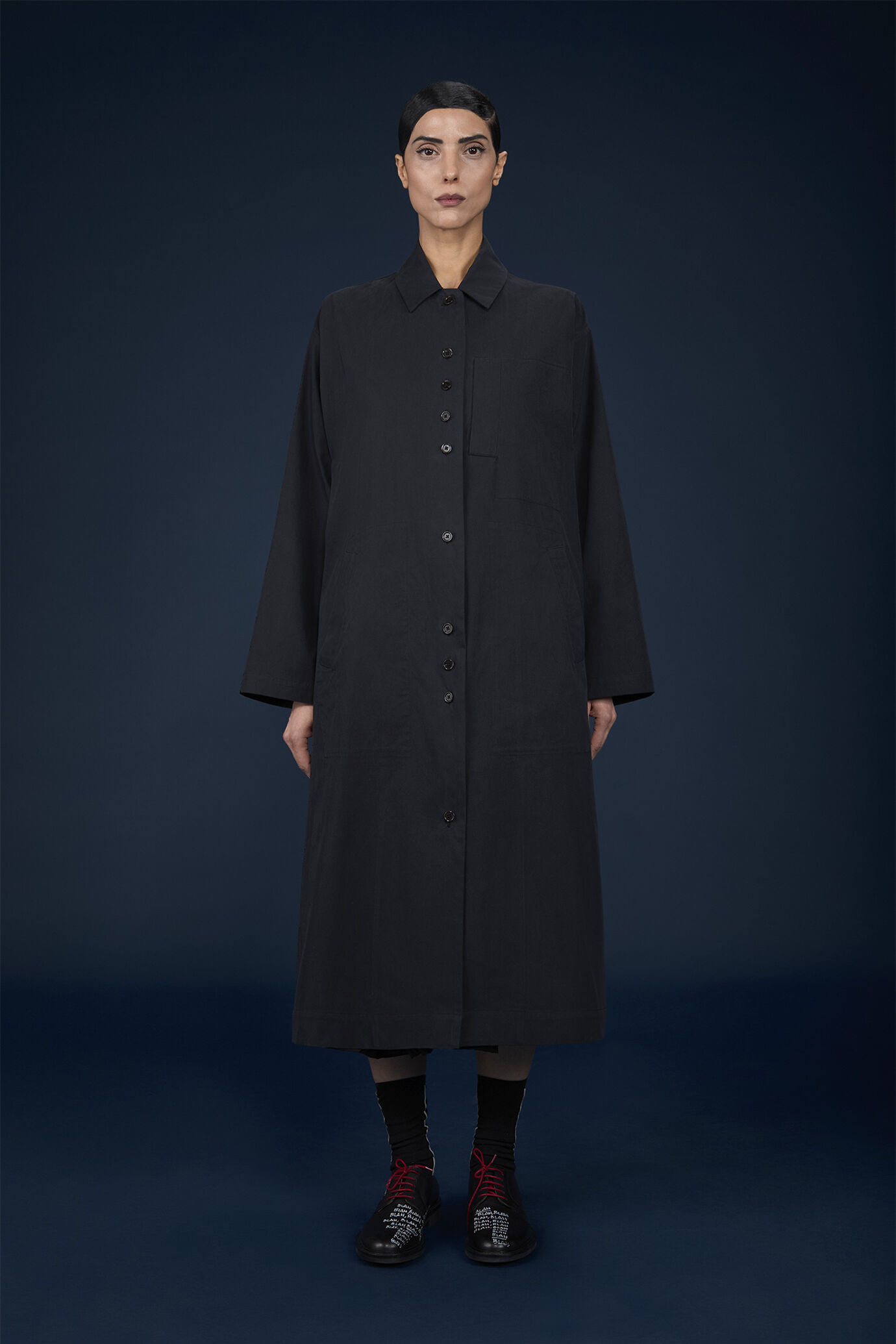Women's flared raincoat with side slits featuring buttons ...